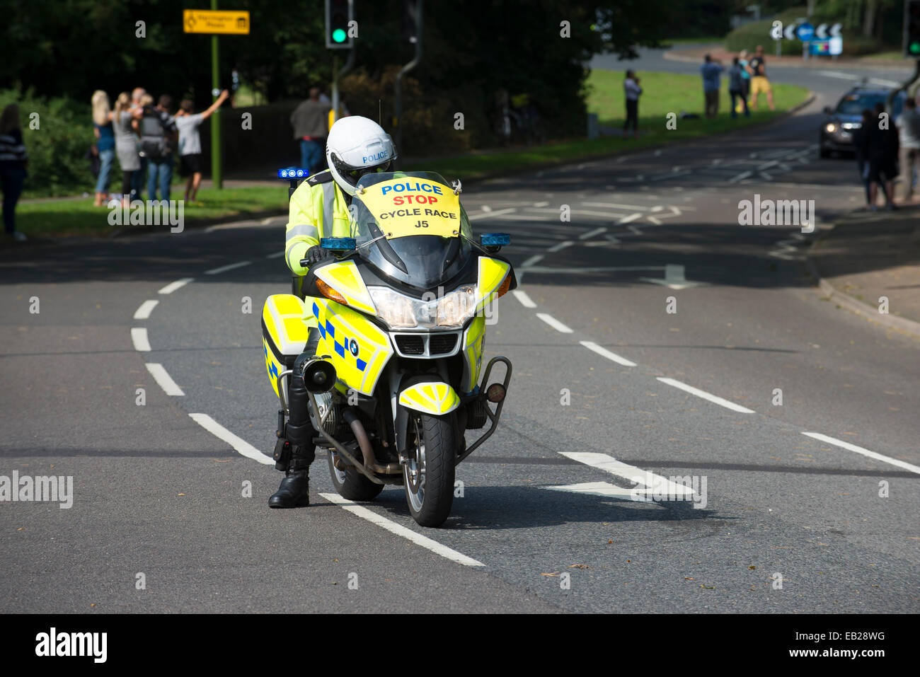 A Police motorcyclist performs a rolling road closure for the Tour of ...