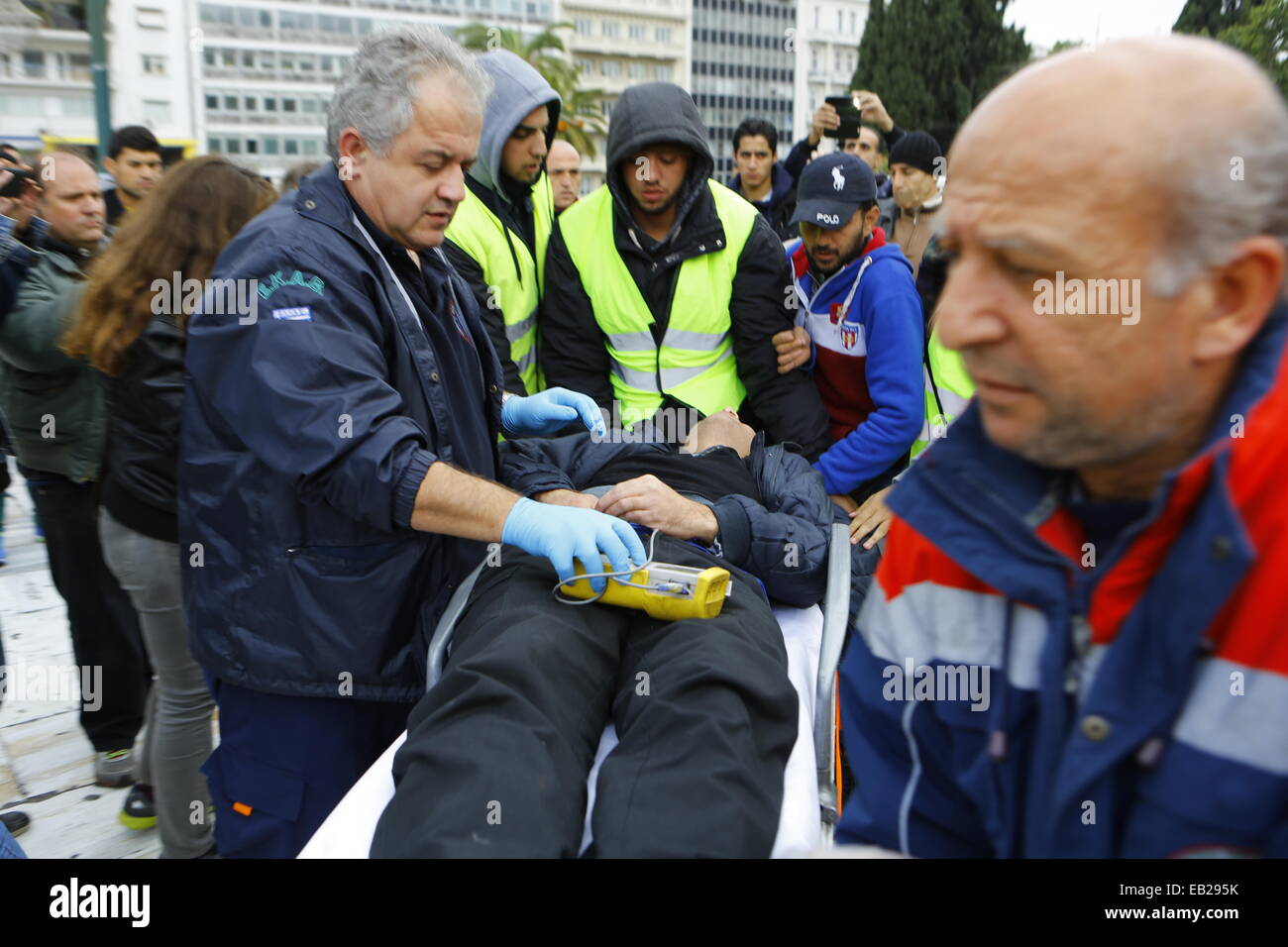 Athens, Greece. 25th Nov, 2014. A collapsed Syrian refugee is carried ...