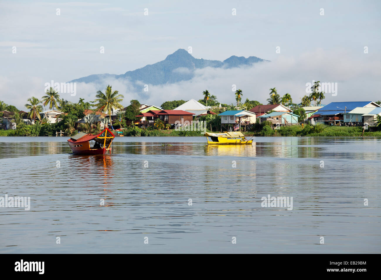 Sarawak River at Kuching in Malaysian Borneo with river boats crossing ...