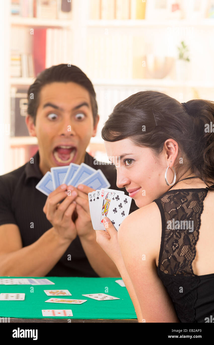 young couple playing cards cuarenta Stock Photo - Alamy