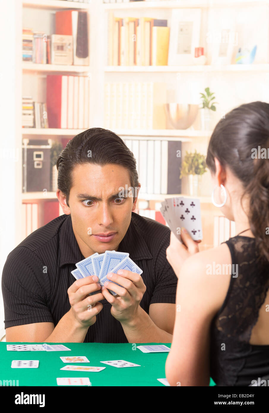 young couple playing cards cuarenta Stock Photo - Alamy