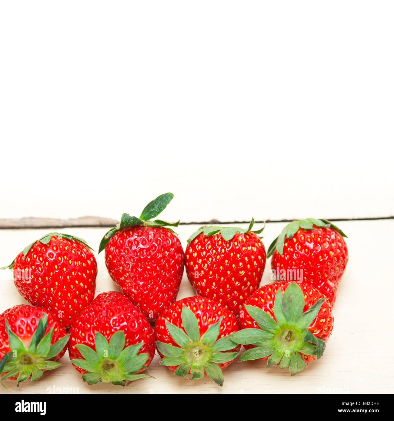 fresh organic strawberry over white rustic wood table Stock Photo - Alamy