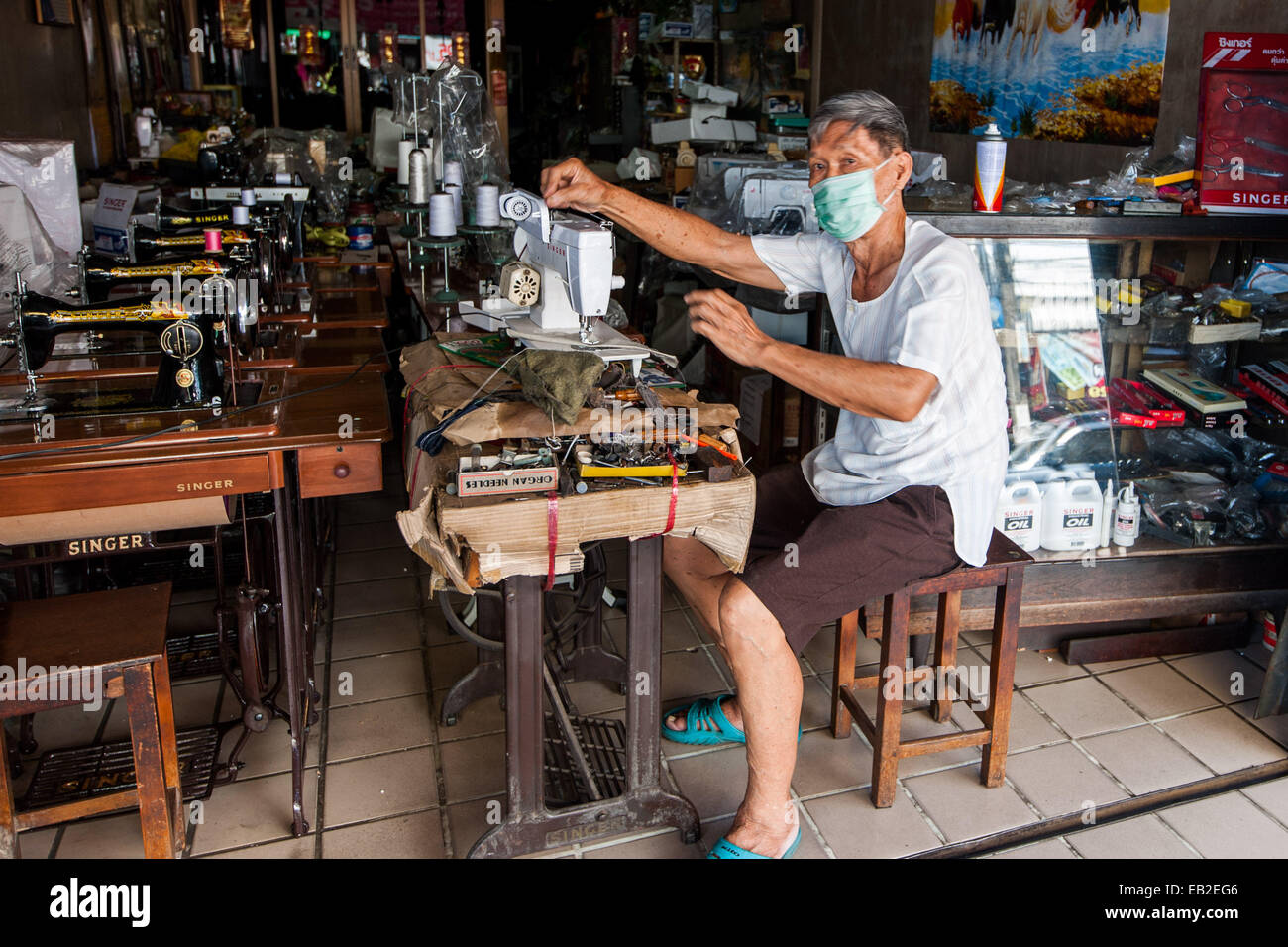 Man using a sewing machine in a shop in Chiang Mai, Thailand Stock ...
