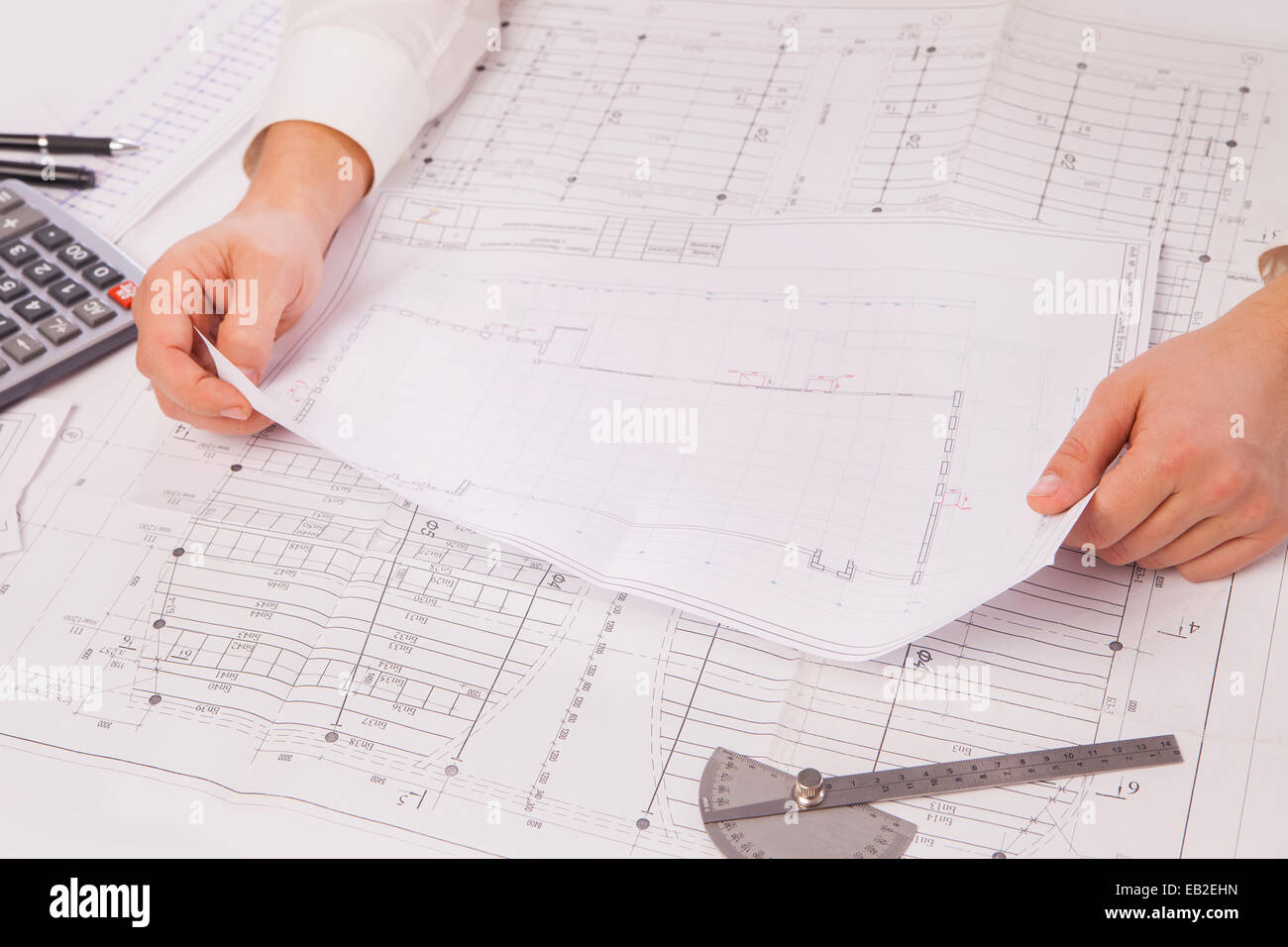 Close-up of Male Architect hand holding Blueprint over white Stock ...