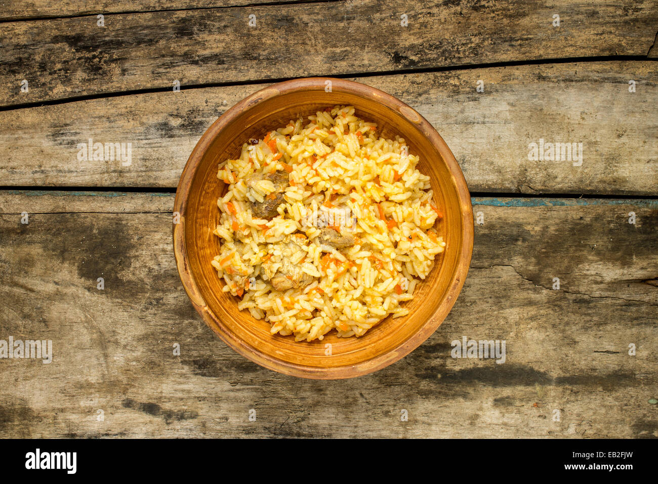 Traditional asian pilaf on wood background. Plov in clayware bowl Stock ...