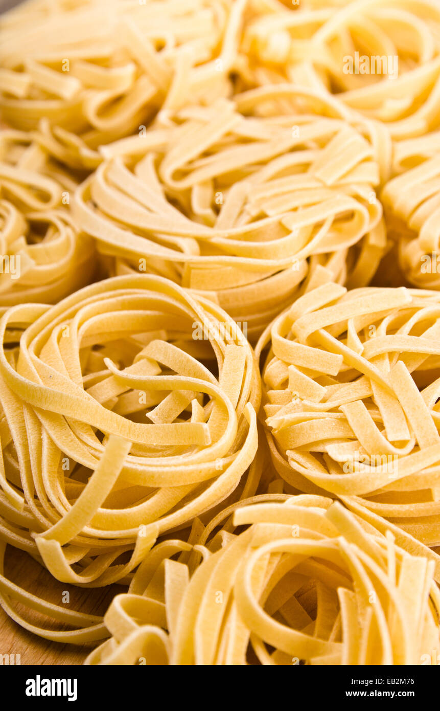 Raw tagliatelle close-up background Stock Photo - Alamy