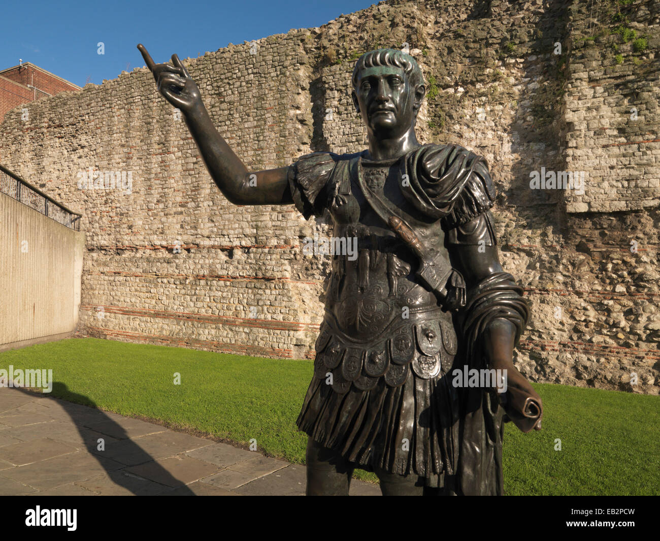 Detail of statue of Emperor Trajan and section of Roman wall, London ...