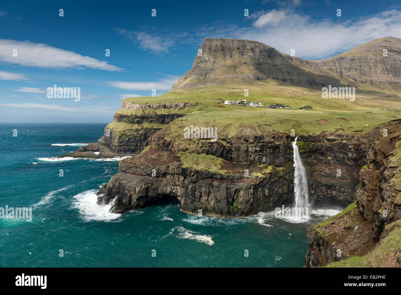 Waterfall on the cliffs near a village, Gásadalur, Vágar, Faroe Islands ...