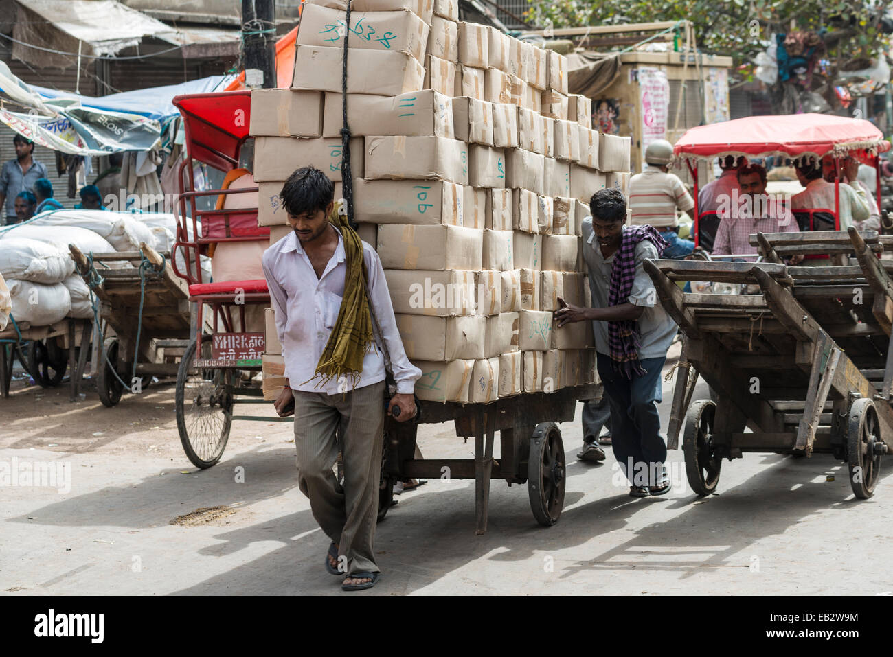 Men transporting goods on a hand cart on Khari Baoli Road, Old Delhi ...