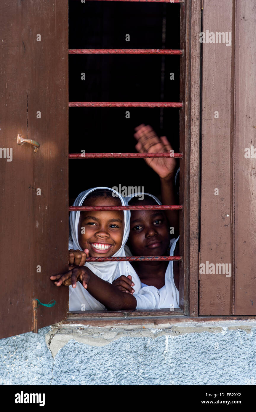 Muslim girls wave and laugh from a school classroom window Stock Photo ...