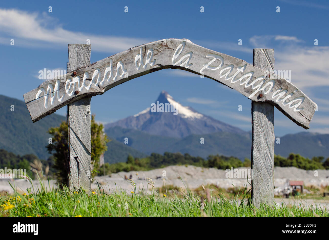 The Mercados de la Patagonia sign frames Corcovado Volcano in Corcovado ...