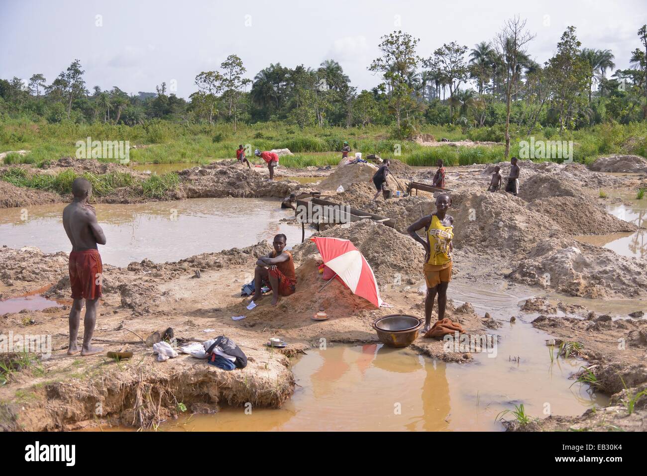 Diamond hunters searching for diamonds with sieves and shovels in a ...