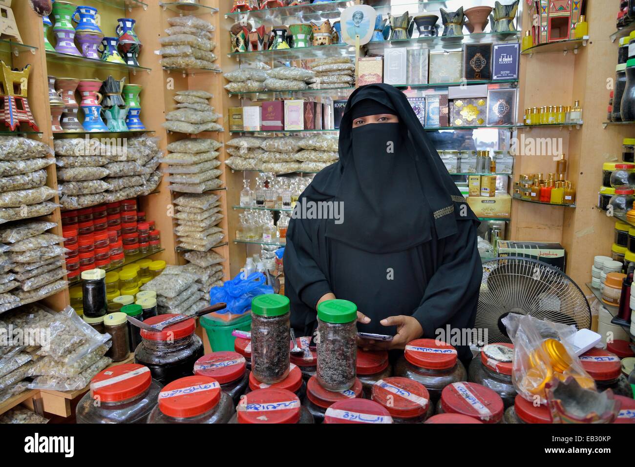 Incense seller at her booth on the incense market, Salalah, Dhofar ...