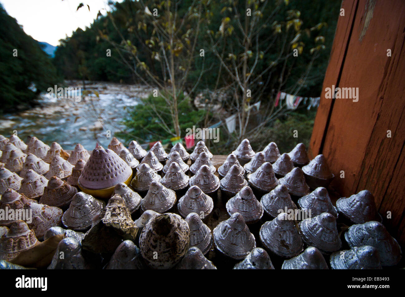 People place religious tsa tsa on a bridge above an alpine river in a ...