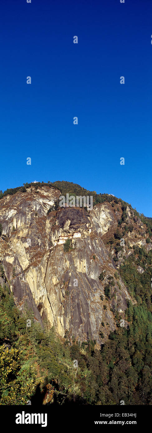 An ancient Buddhist monastery perched on a sheer cliff face above a ...