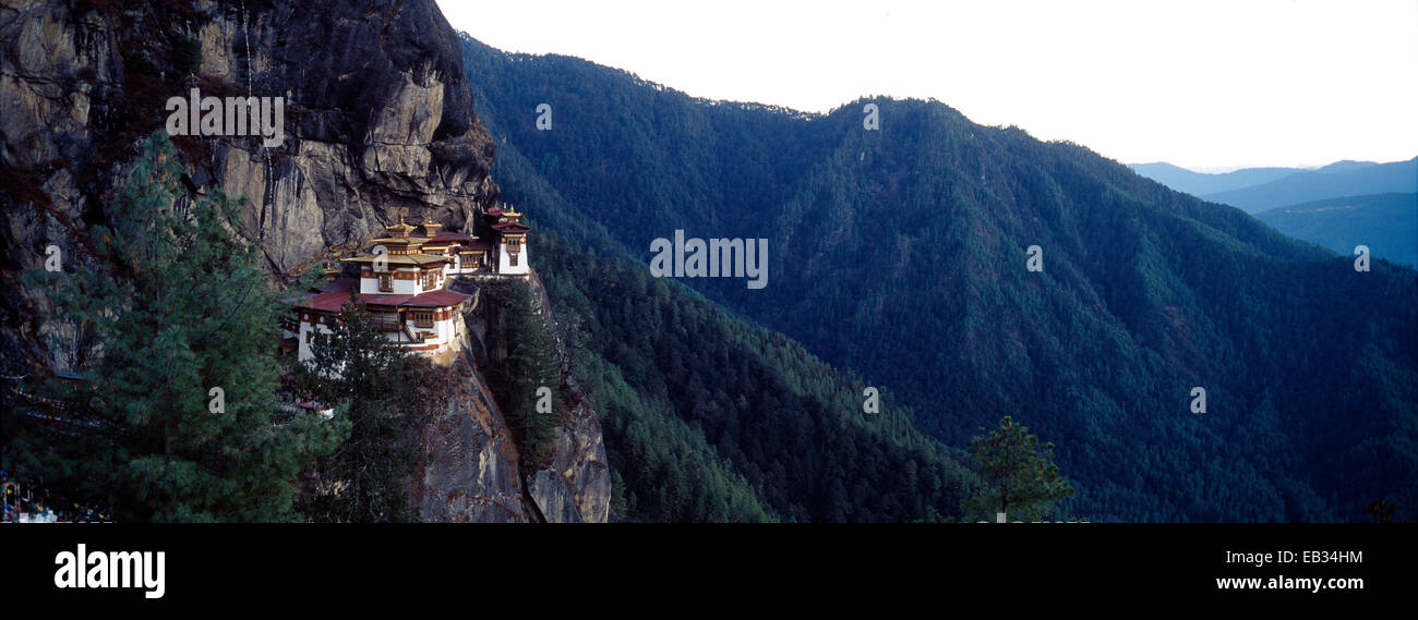 An ancient Buddhist monastery perched on a sheer cliff face above a ...