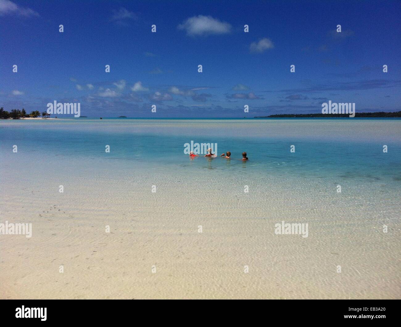 Mother and three children swimming in sea, Cook Islands Stock Photo - Alamy