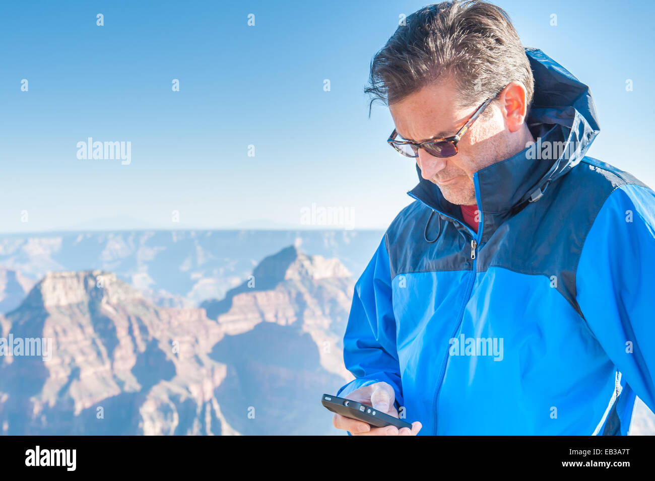 Man using a mobile phone, Grand Canyon, Arizona, USA Stock Photo - Alamy