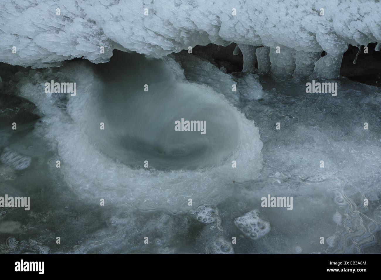 Nature creates a fascinating drain system in the ice Stock Photo - Alamy