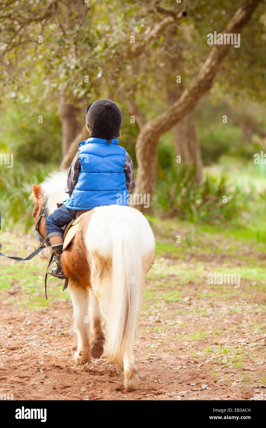 Boy riding a pony, Morocco Stock Photo - Alamy