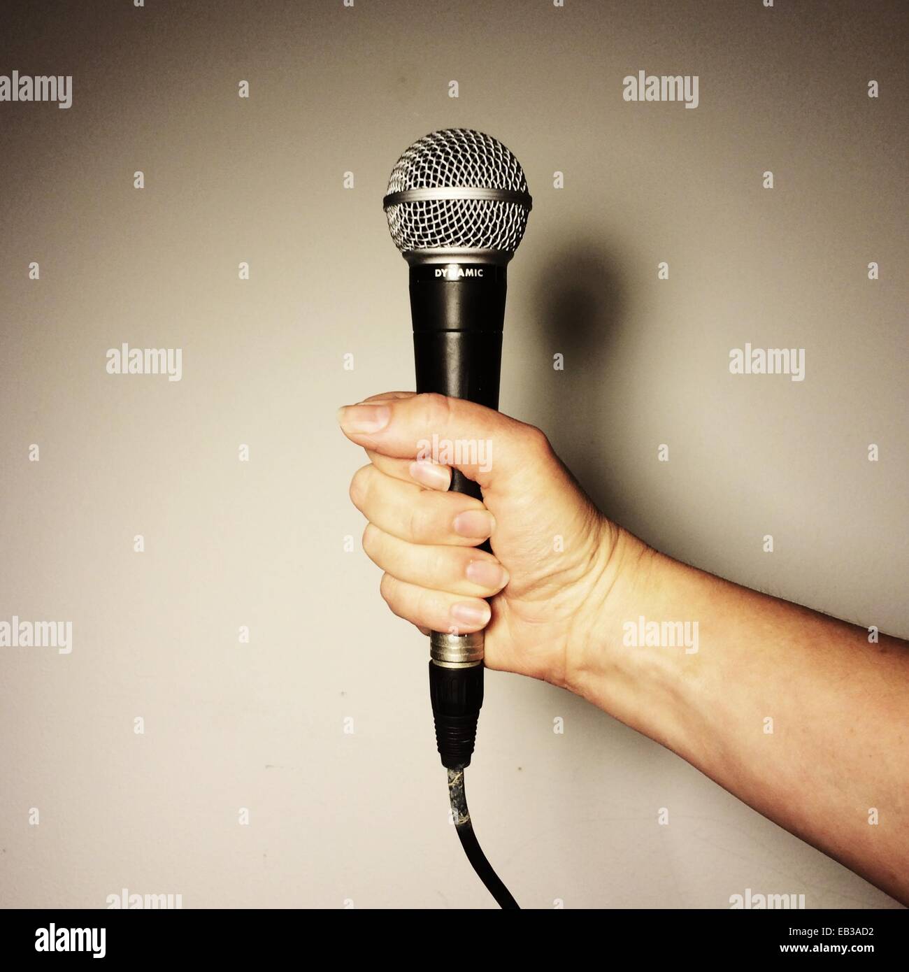 Hand holding microphone Stock Photo - Alamy