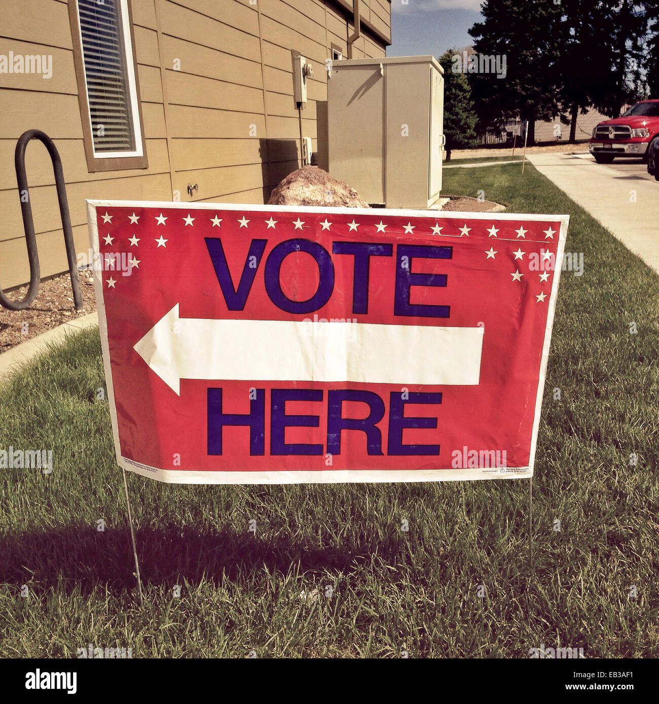Voting sign on lawn Stock Photo - Alamy