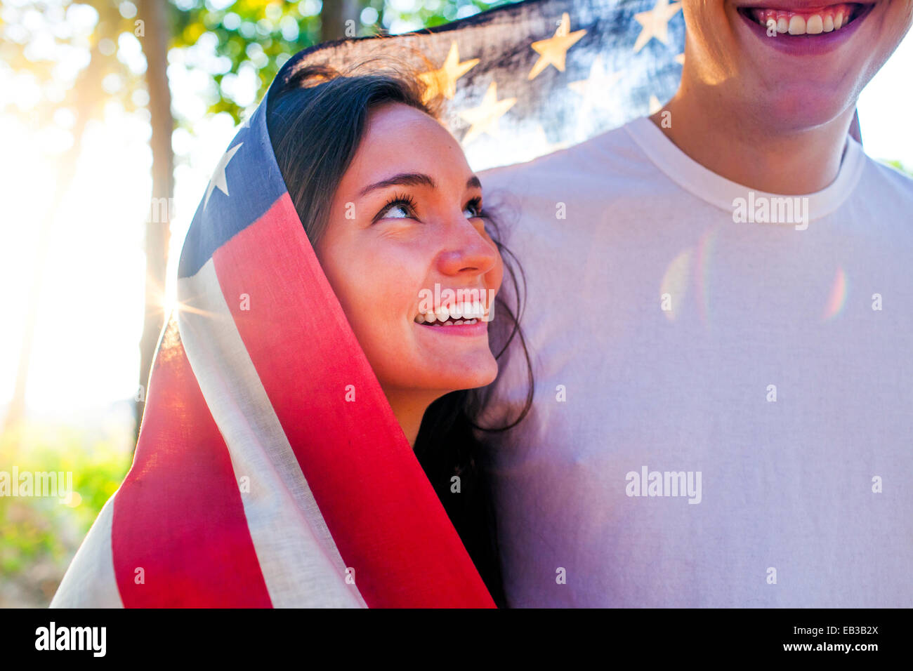 Caucasian couple wrapped in American flag Stock Photo - Alamy