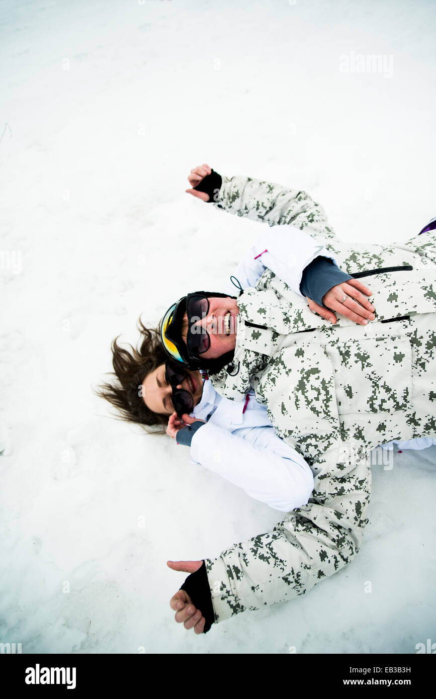 Caucasian couple playing in snow Stock Photo - Alamy