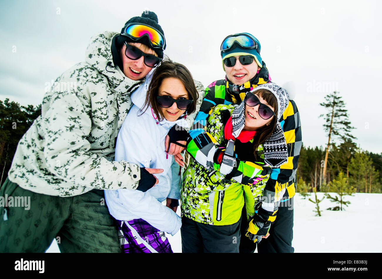 Caucasian friends smiling in snow Stock Photo - Alamy