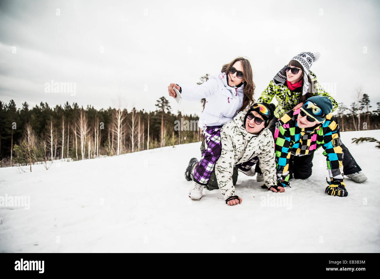 Caucasian friends smiling in snow Stock Photo - Alamy