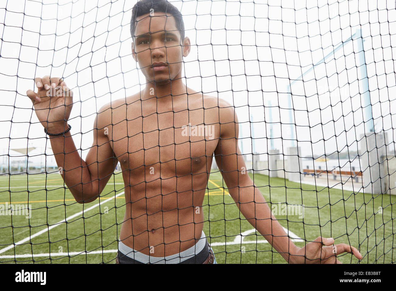 Man standing in soccer net on field Stock Photo - Alamy