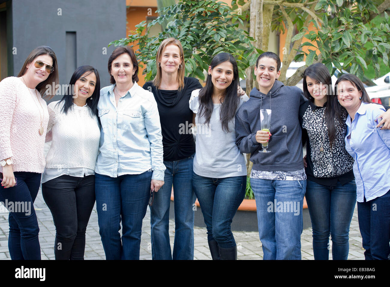 Smiling friends standing outdoors Stock Photo - Alamy