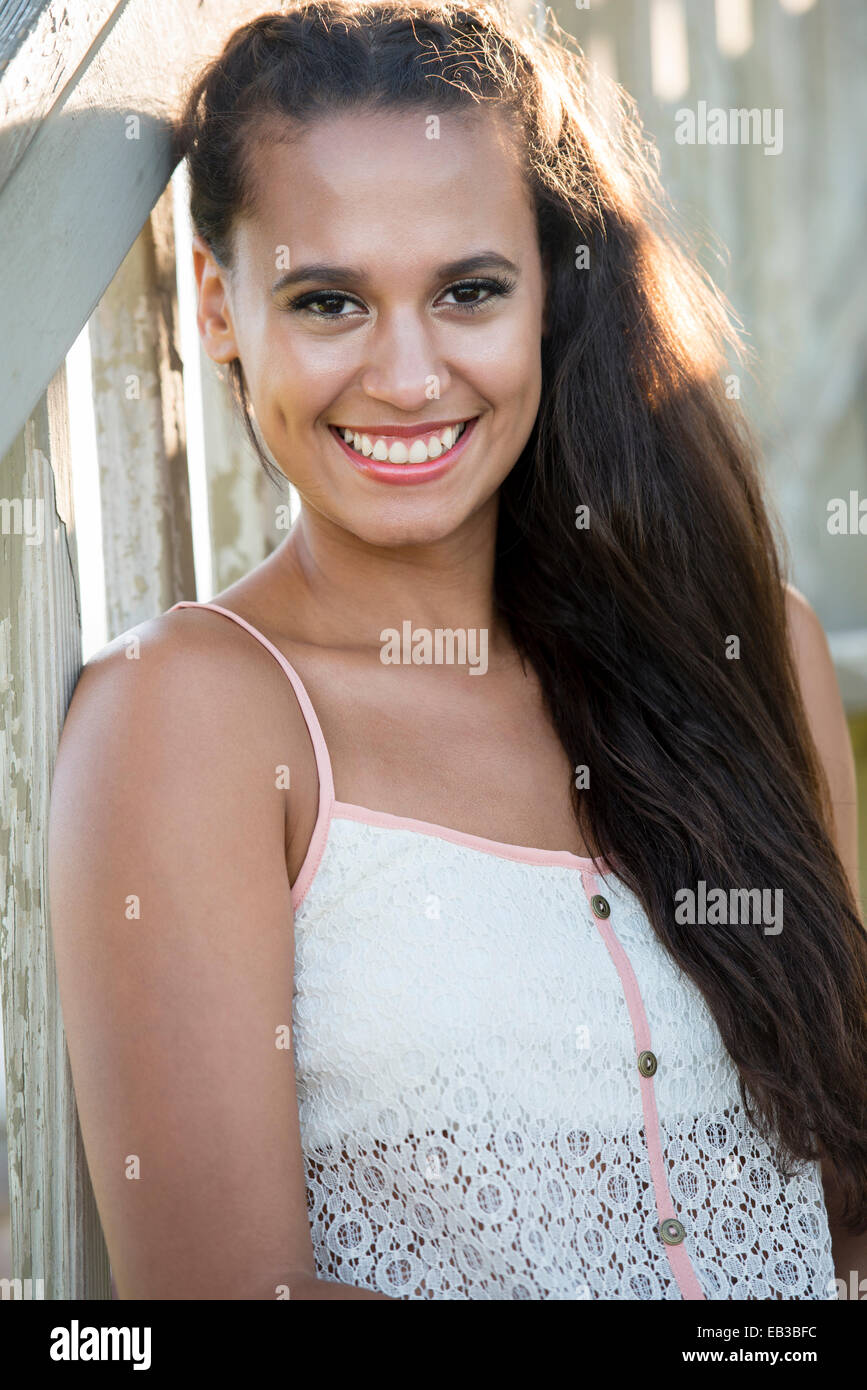 Mixed race woman sitting on wooden steps Stock Photo - Alamy