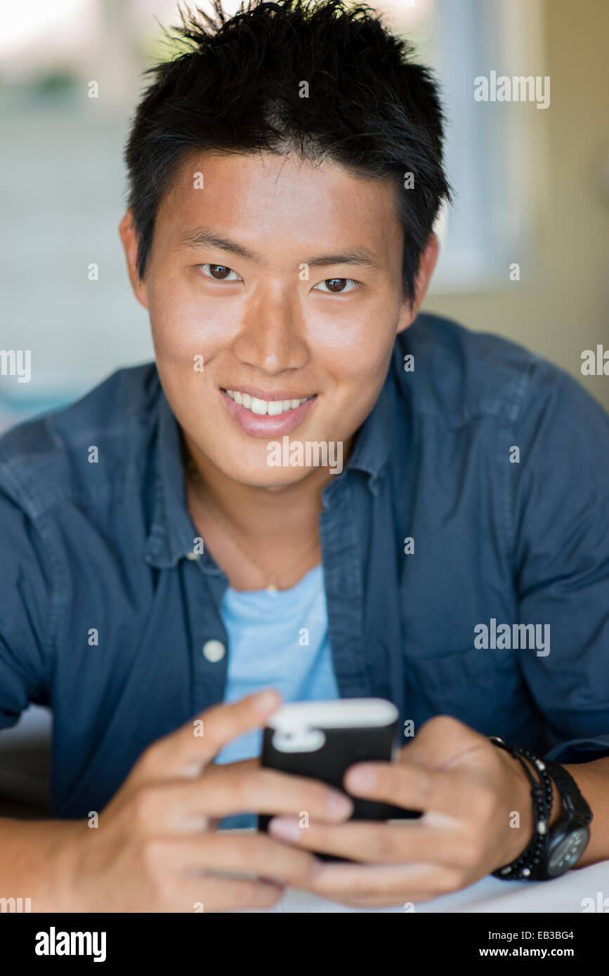 Korean man using cell phone Stock Photo - Alamy