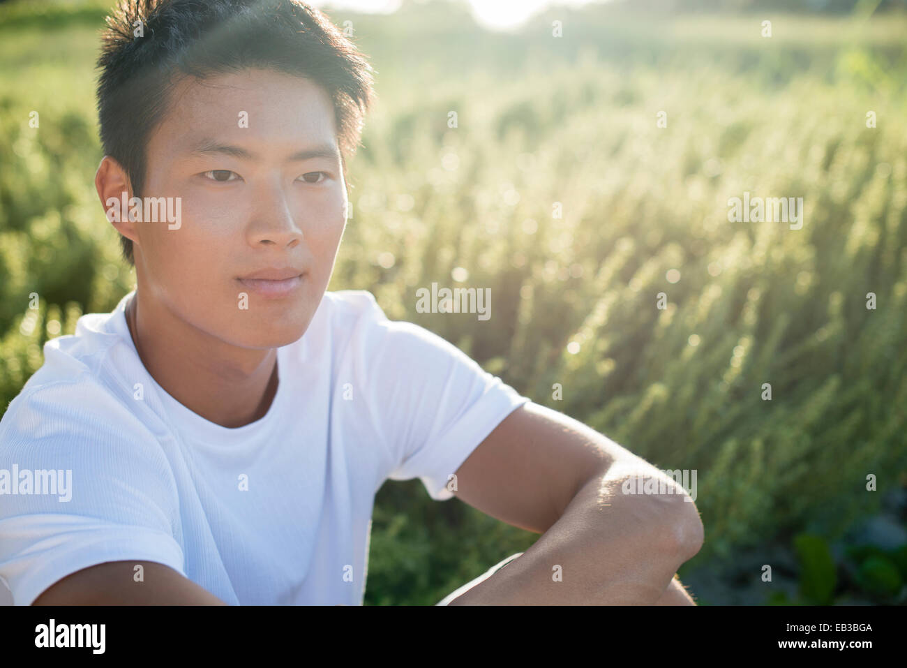 Korean man sitting outdoors Stock Photo - Alamy