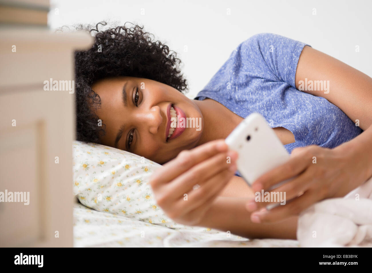 Cell phone in bed hi-res stock photography and images - Alamy