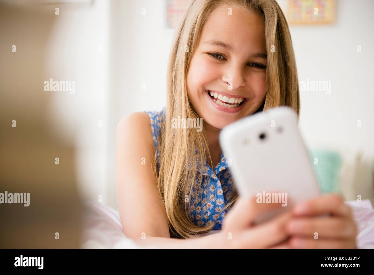 Smiling girl using smart hi-res stock photography and images - Alamy