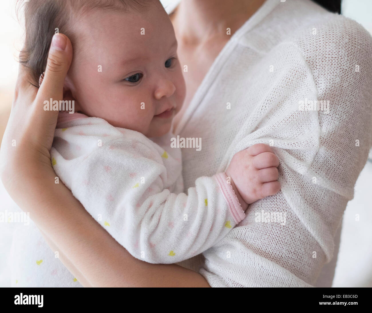Woman holding baby girl hi-res stock photography and images - Alamy