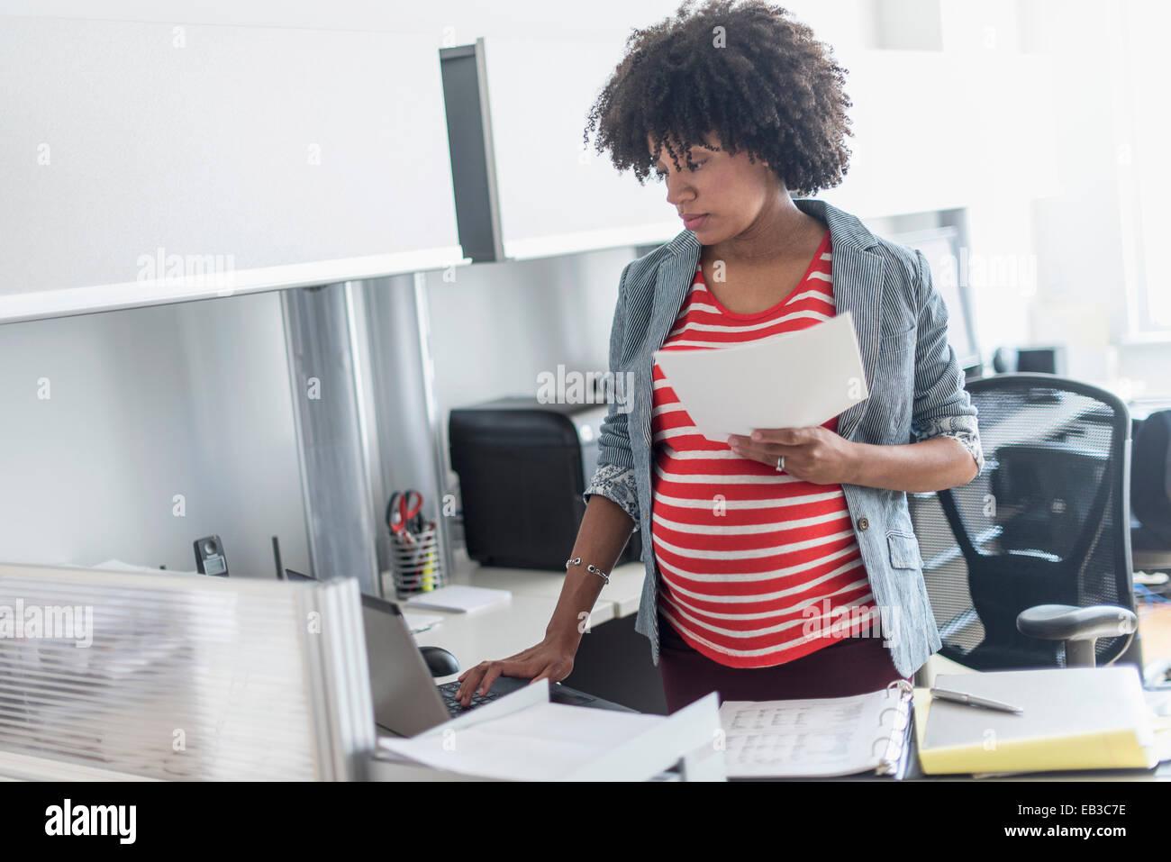 Pregnant African American businesswoman working in office Stock Photo ...
