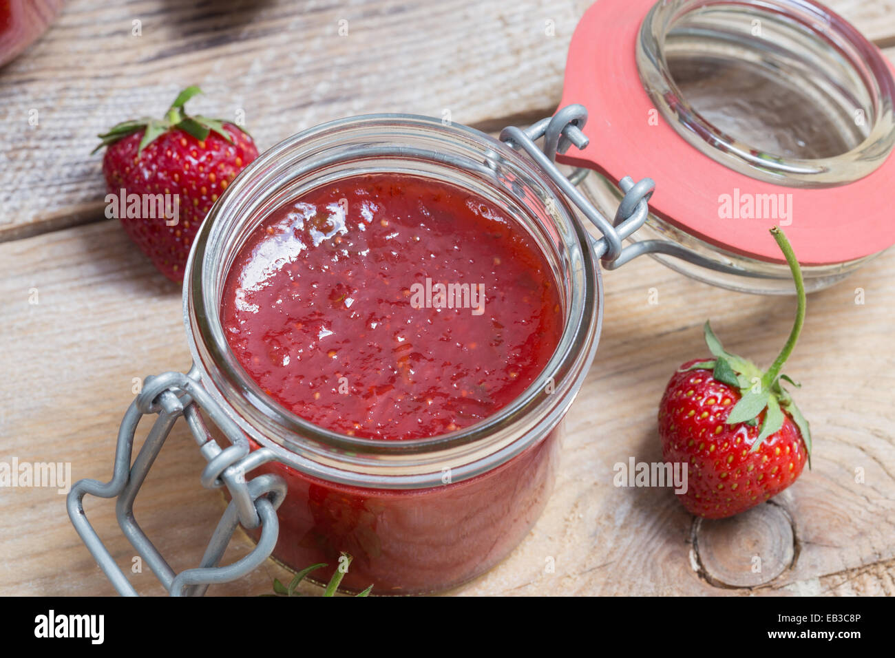 Strawberry jam in a jar on wood Stock Photo - Alamy