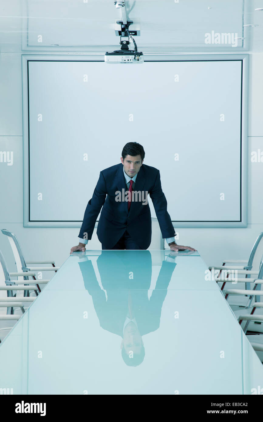 Businessman standing at the head of conference table in office Stock ...