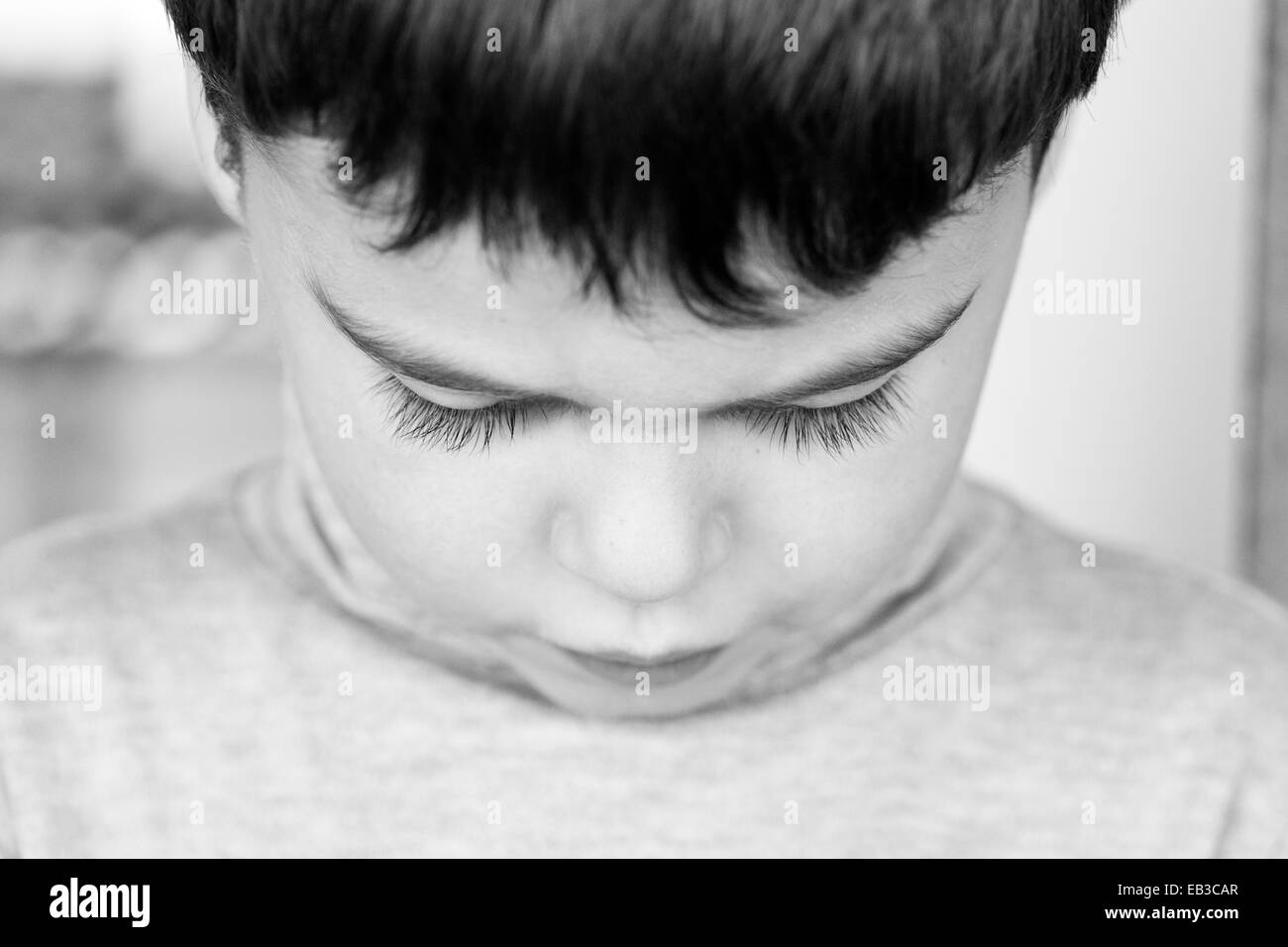 Close-up portrait of a boy looking down Stock Photo - Alamy