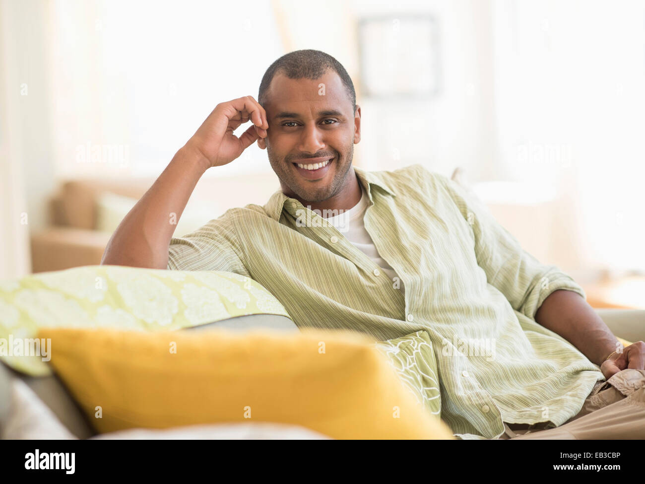 Smiling mixed race man sitting hi-res stock photography and images - Alamy