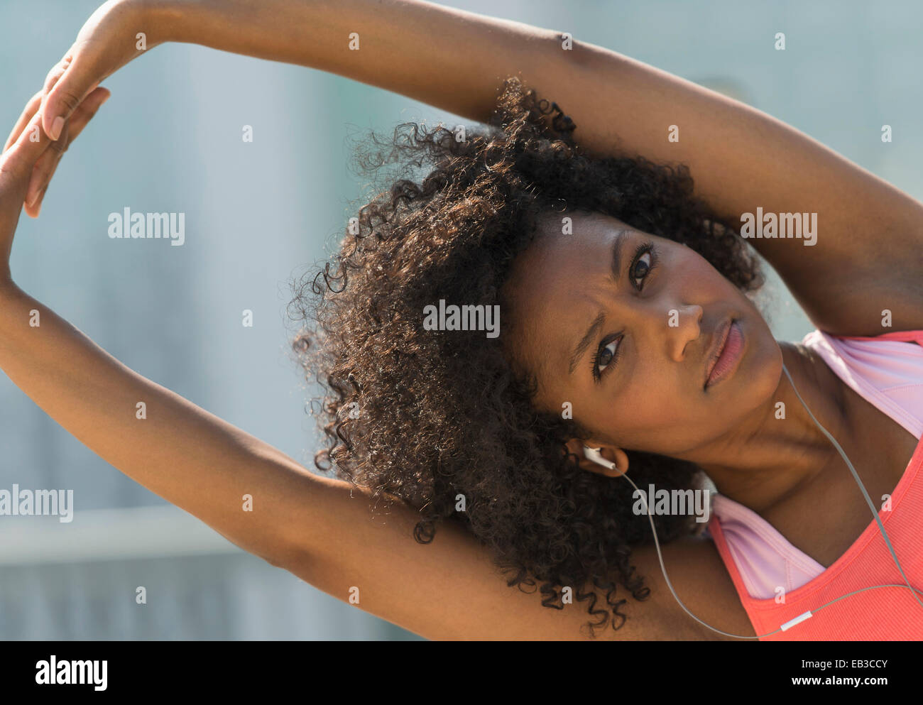 Mixed race woman stretching arms Stock Photo - Alamy
