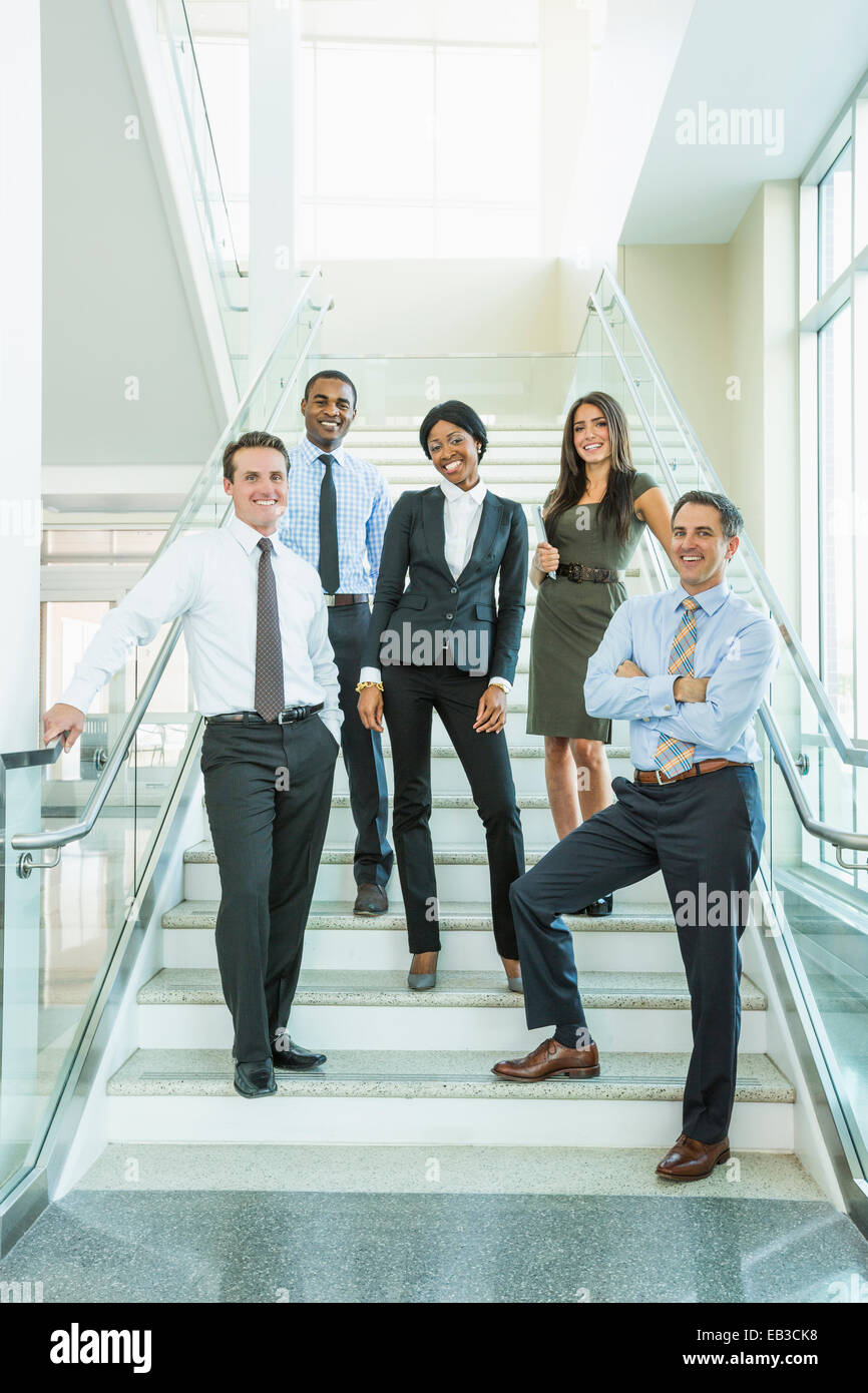 Business people smiling on office staircase Stock Photo - Alamy