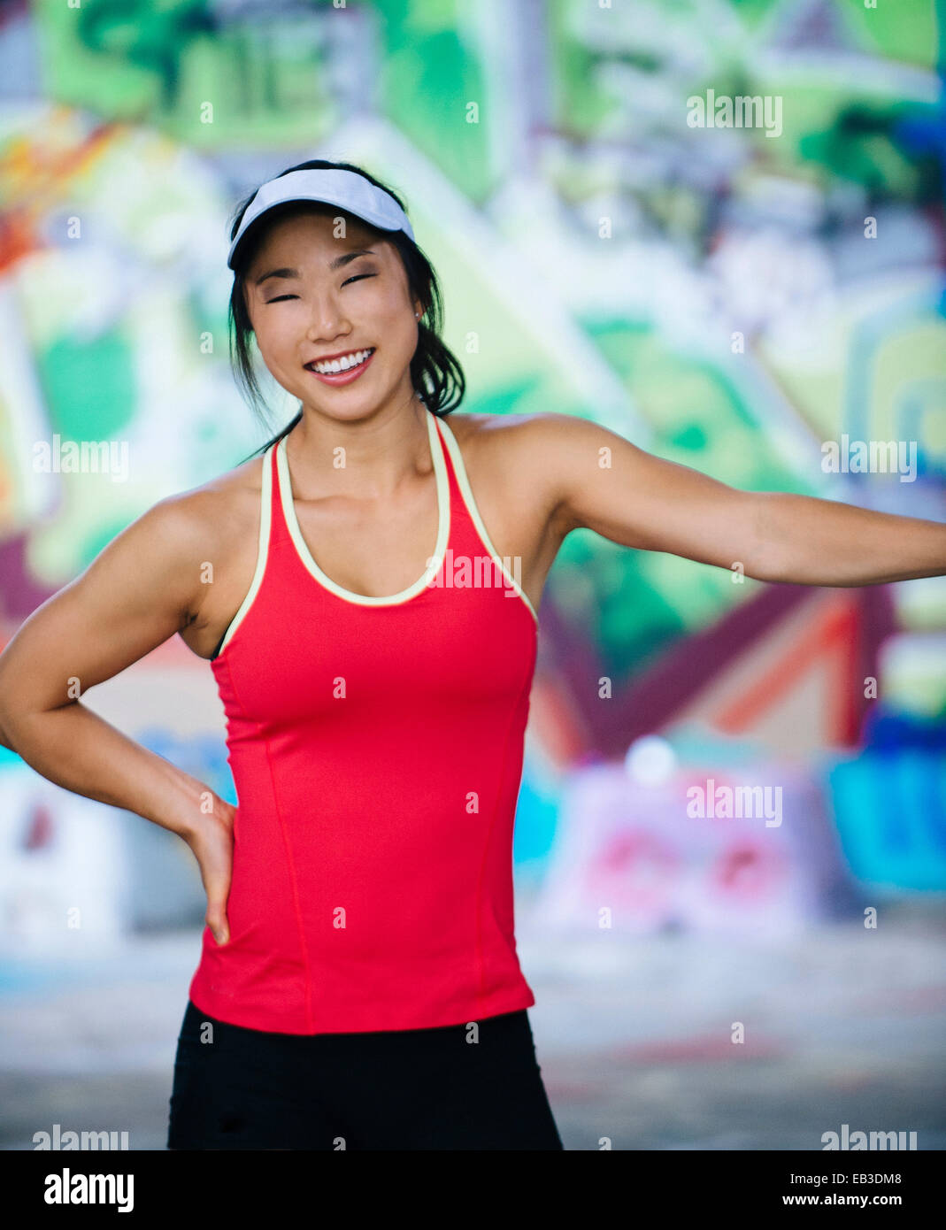 Korean runner smiling near graffiti Stock Photo - Alamy