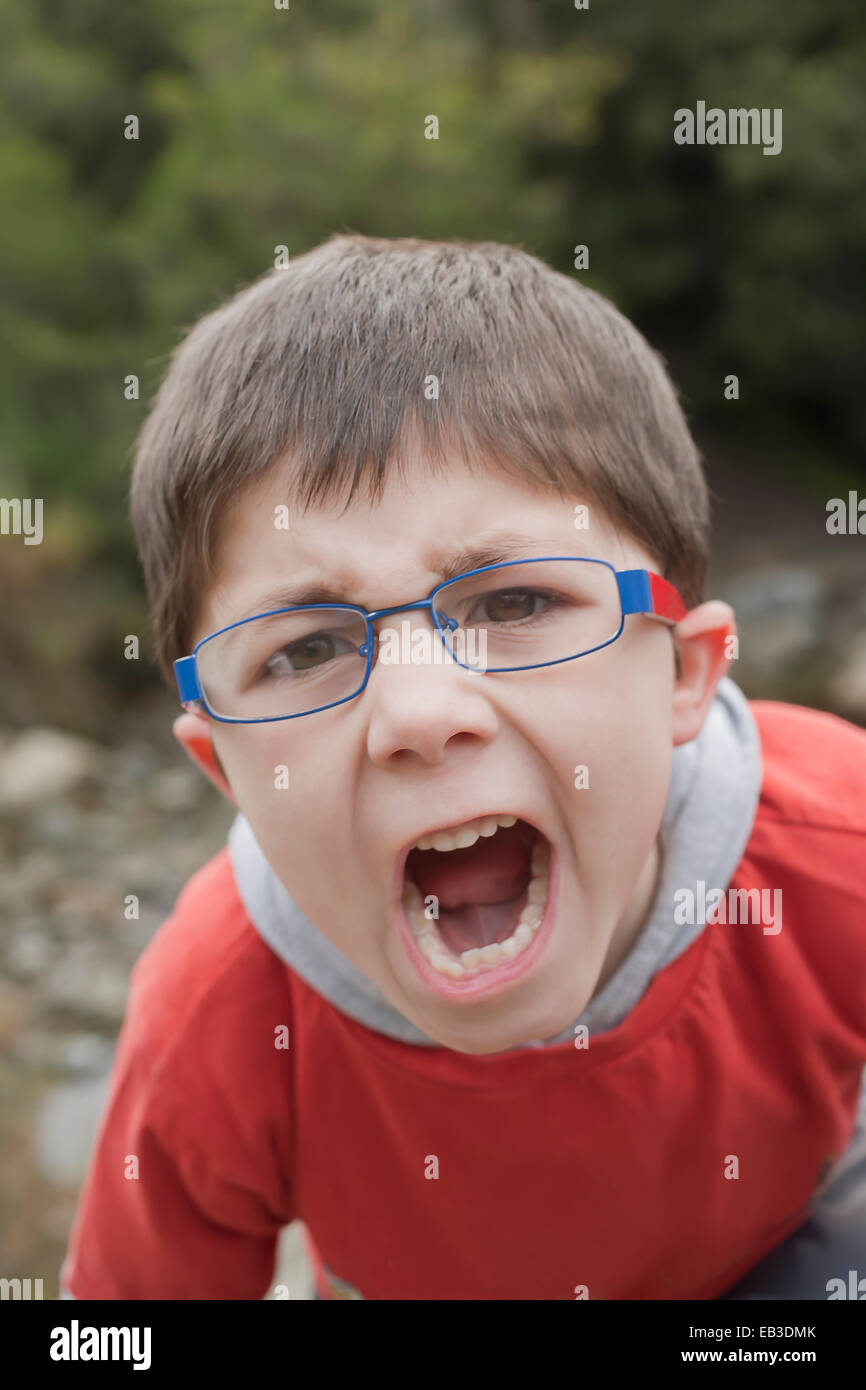 Hispanic boy screaming outdoors Stock Photo - Alamy