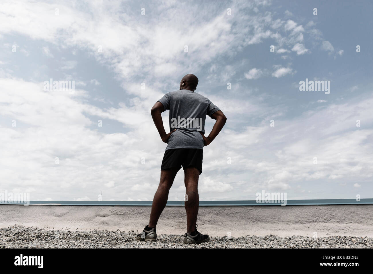 Black runner contemplating landscape Stock Photo - Alamy