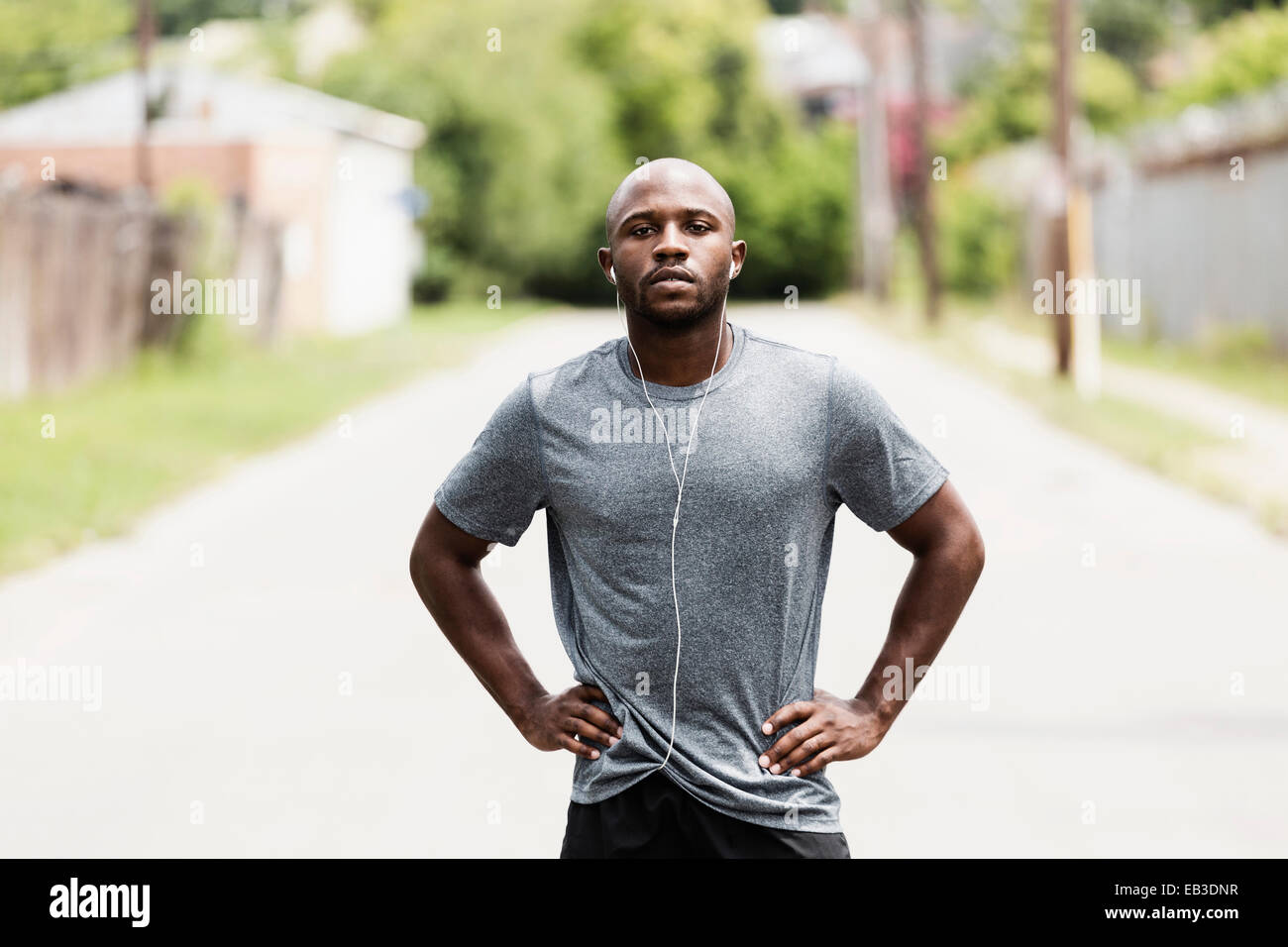 Black runner resting on city street Stock Photo - Alamy