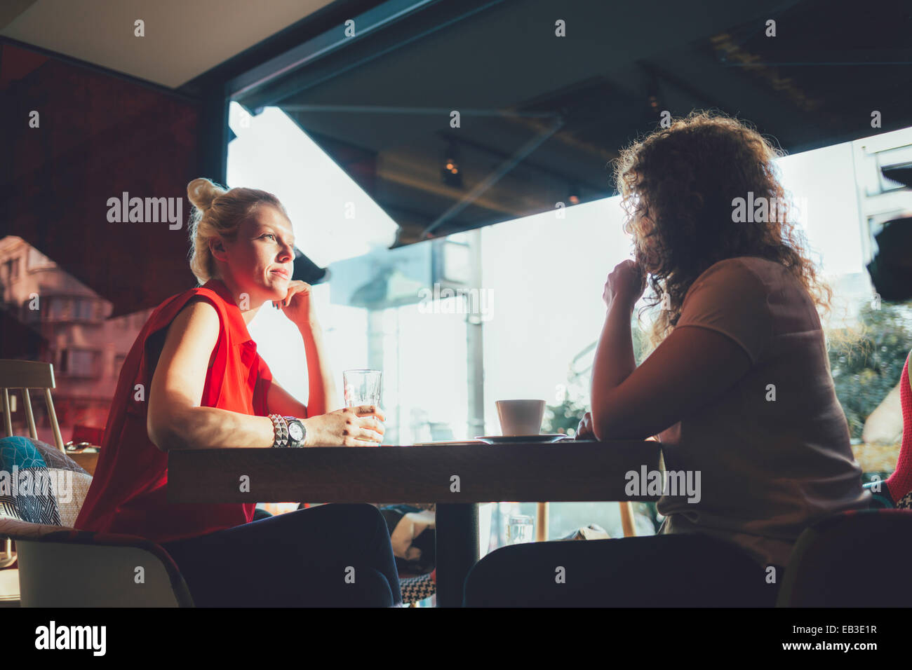 Women relaxing in cafe Stock Photo - Alamy